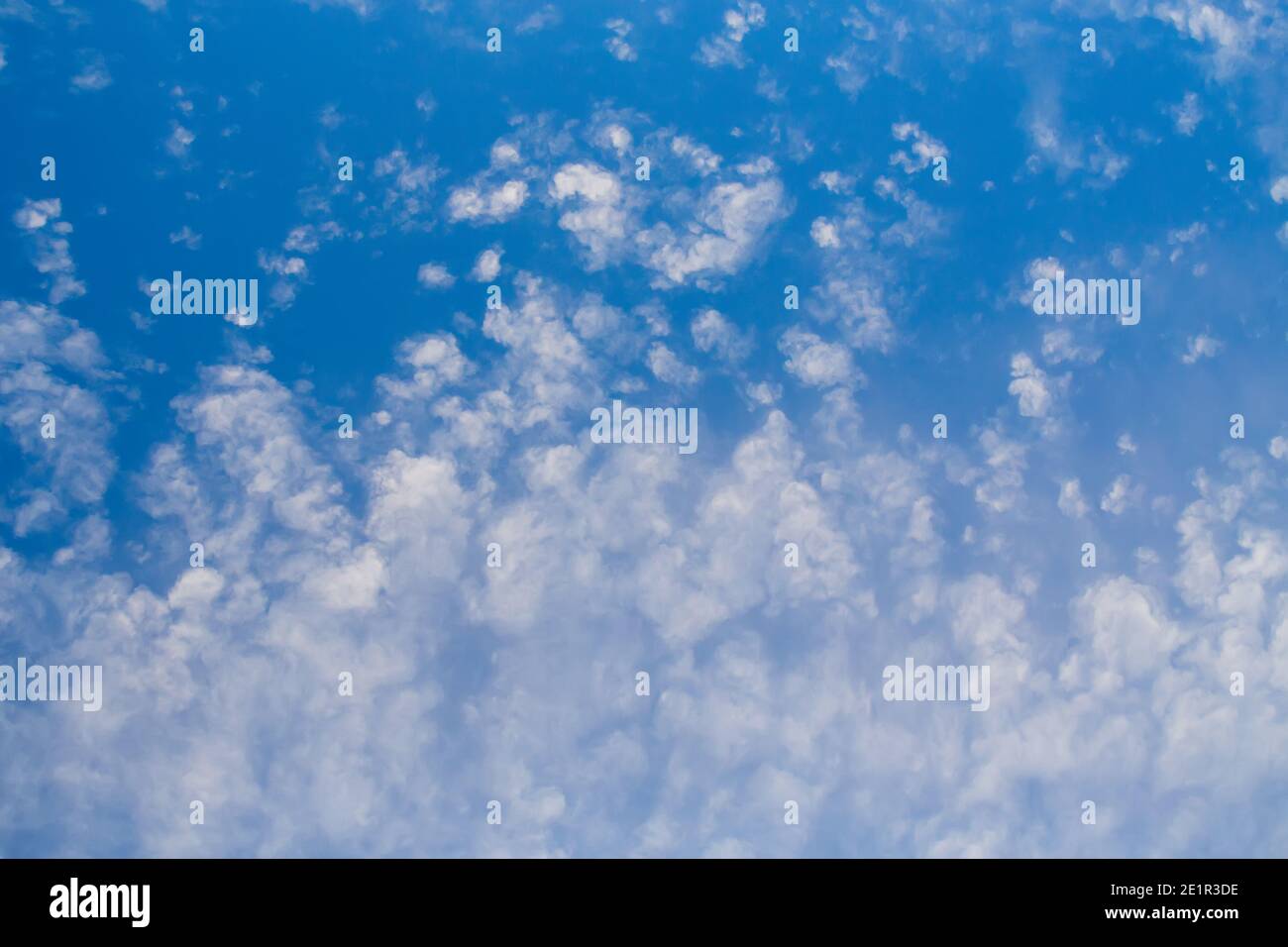Blue clean sky with white picturesque clouds background Stock Photo - Alamy