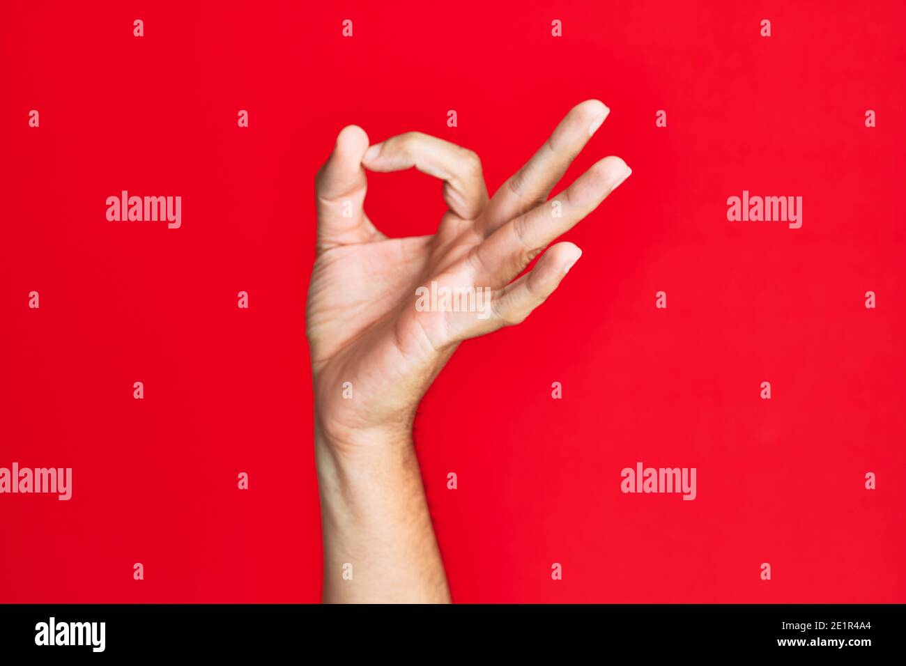 Arm of caucasian white young man over red isolated background gesturing ...