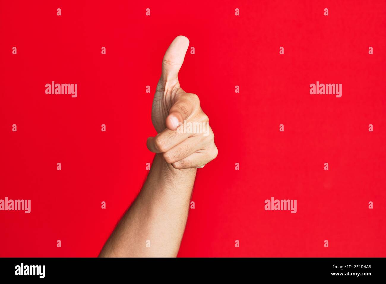 Arm of caucasian white young man over red isolated background pointing ...