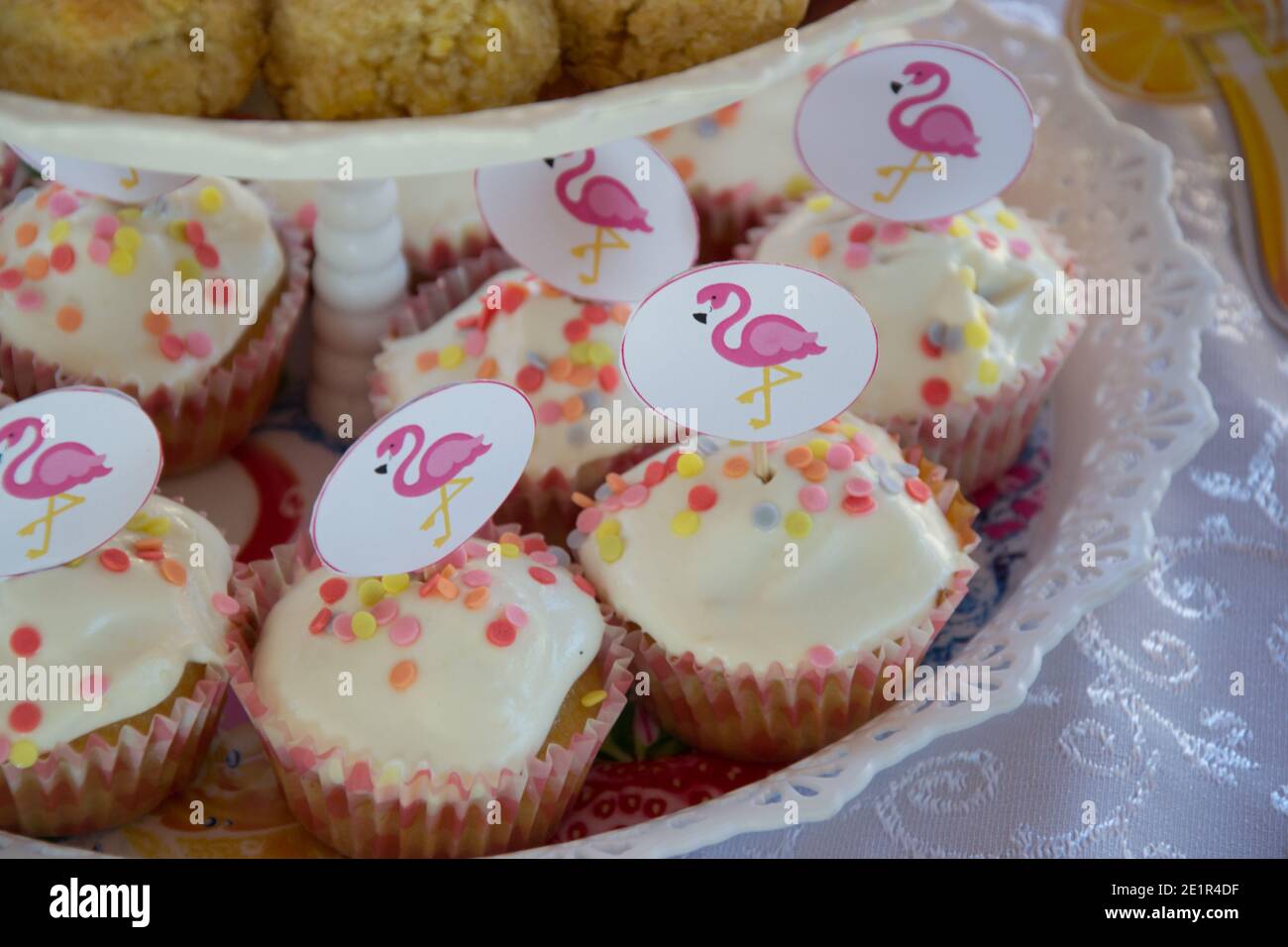 Close-up of homemade sweets with pink flamingo sticks decoration on ...