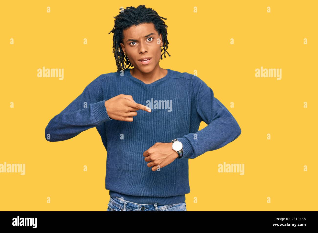 Young african american man wearing casual winter sweater in hurry ...