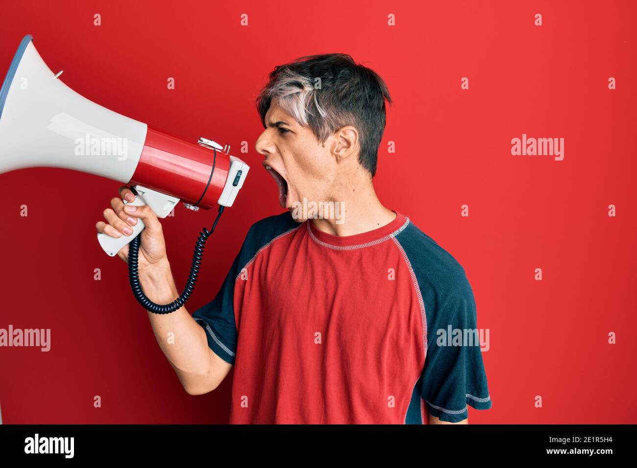 Young man shouting with anger and energy through megaphone Stock Photo ...