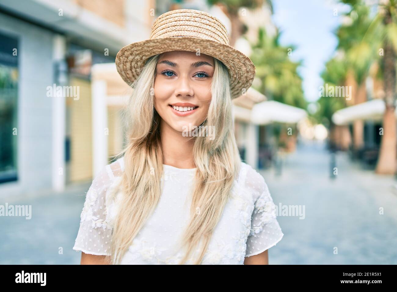 Young caucasian tourist girl smiling happy walking at street of city ...