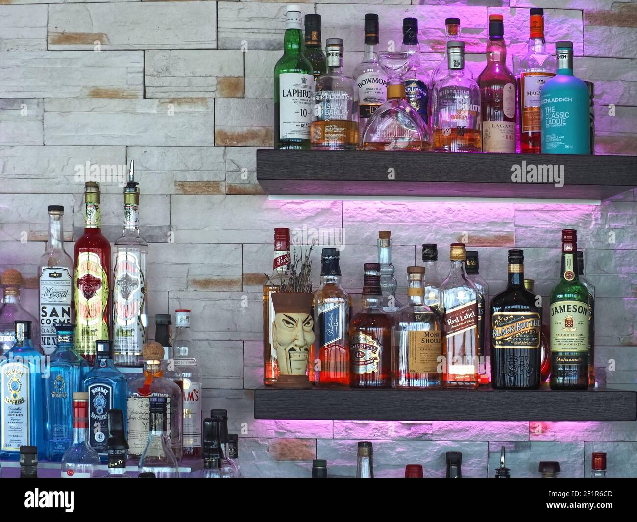 Many bottles of alcohol in a bar to create drinks Stock Photo - Alamy