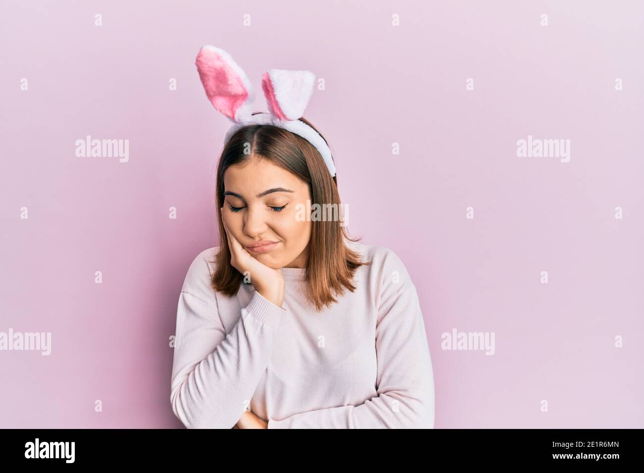 Young beautiful woman wearing cute easter bunny ears thinking looking ...