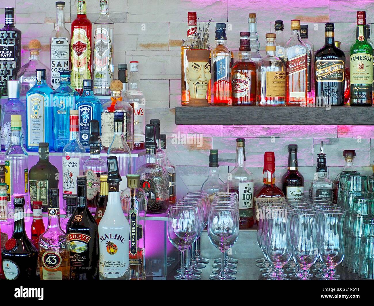 Many bottles of alcohol in a bar to create drinks Stock Photo - Alamy