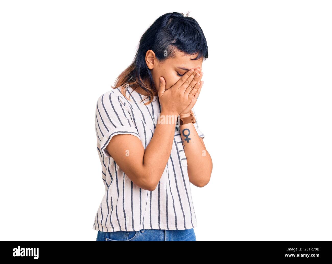 Young woman wearing casual clothes with sad expression covering face ...