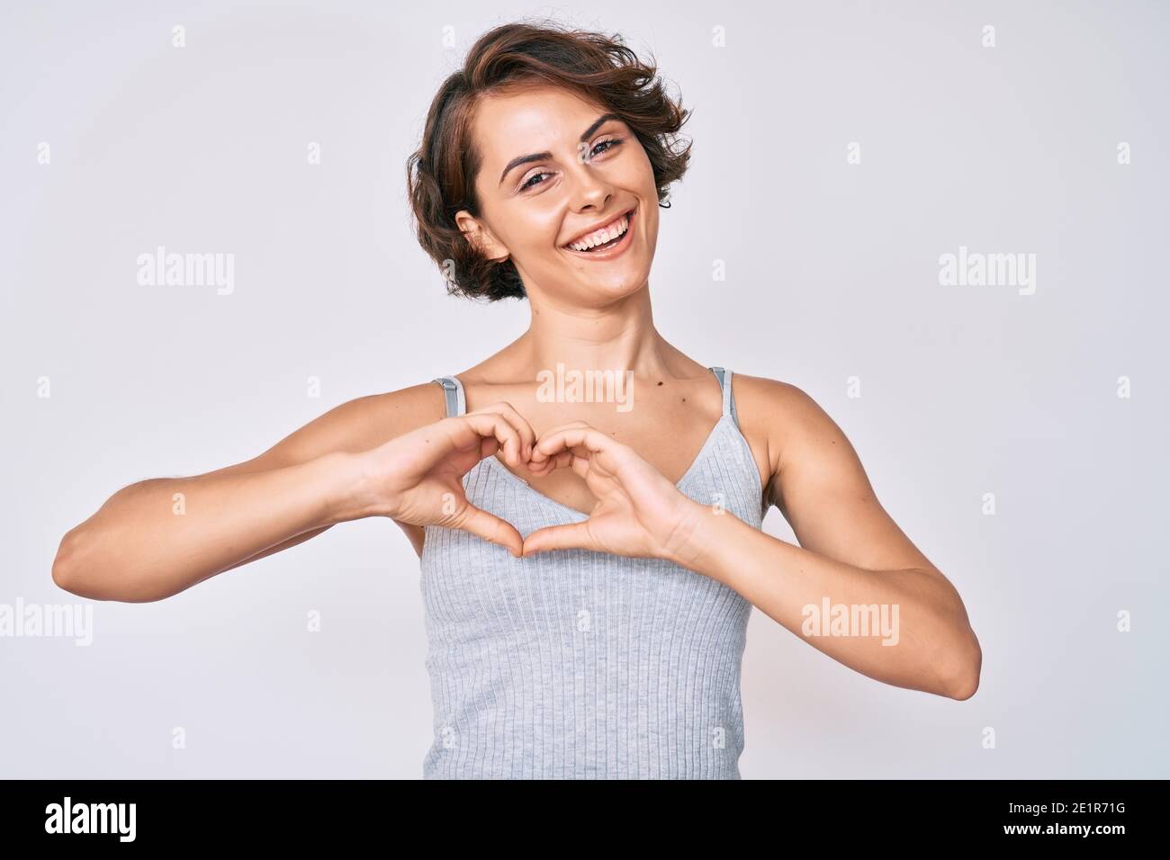 Young hispanic woman wearing casual clothes smiling in love showing ...