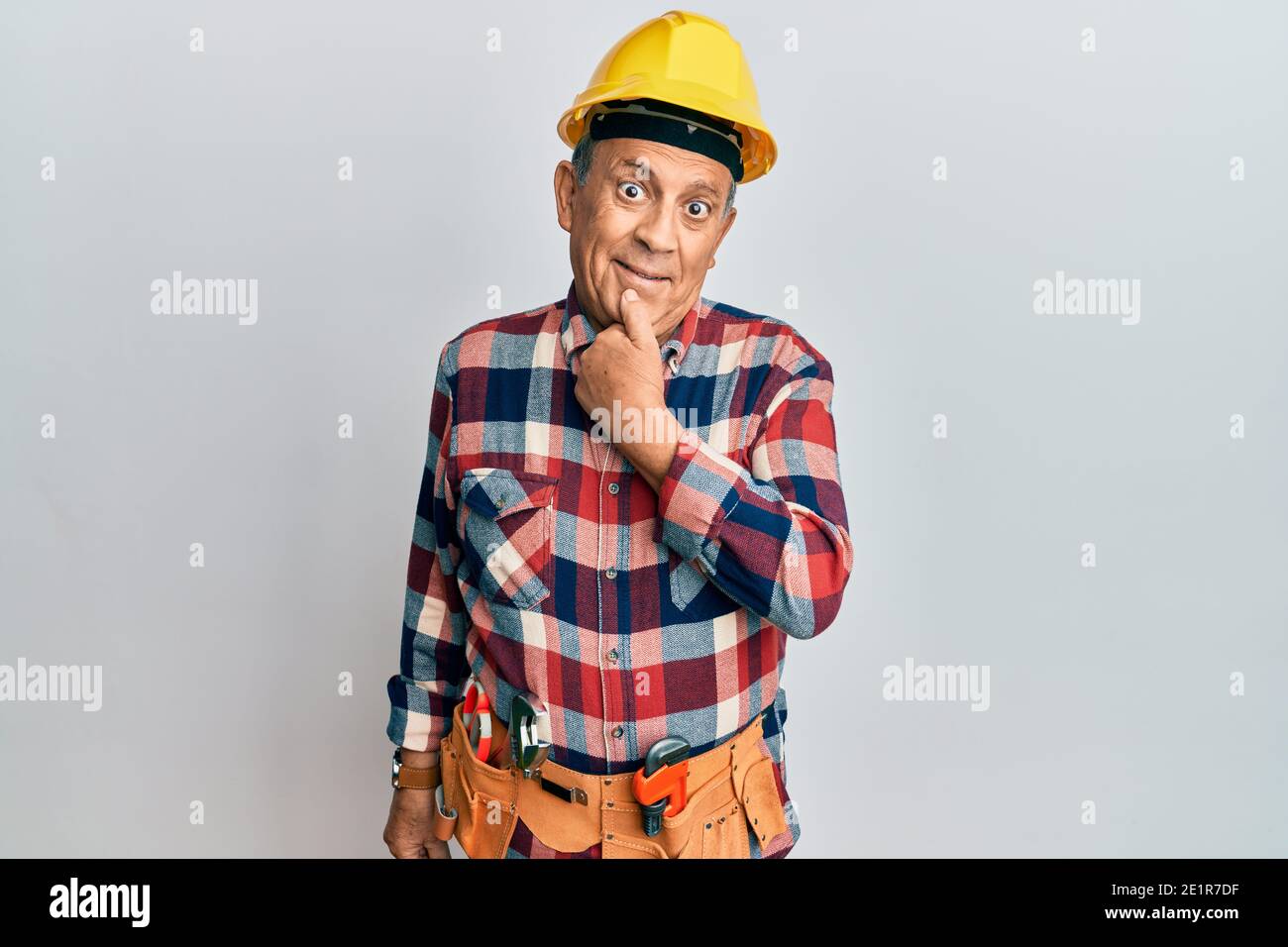 Senior hispanic man wearing handyman uniform looking confident at the ...