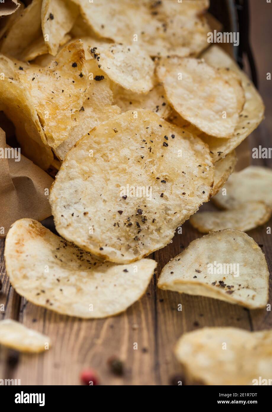 Potato crisps crunchy chips with black pepper in steel snack bucket on ...