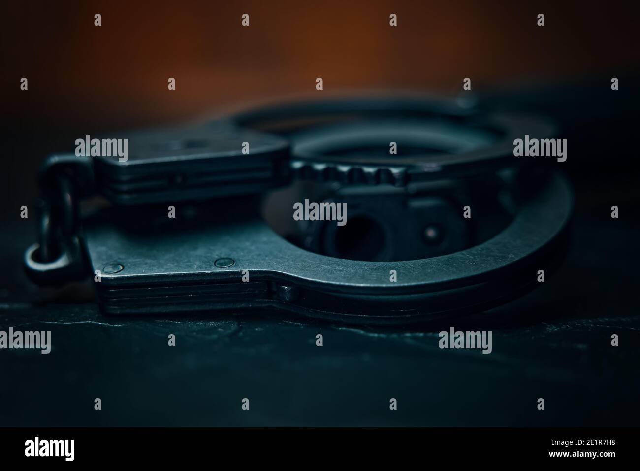 Handcuffs and the muzzle of hand gun close up. Police ammunition ...