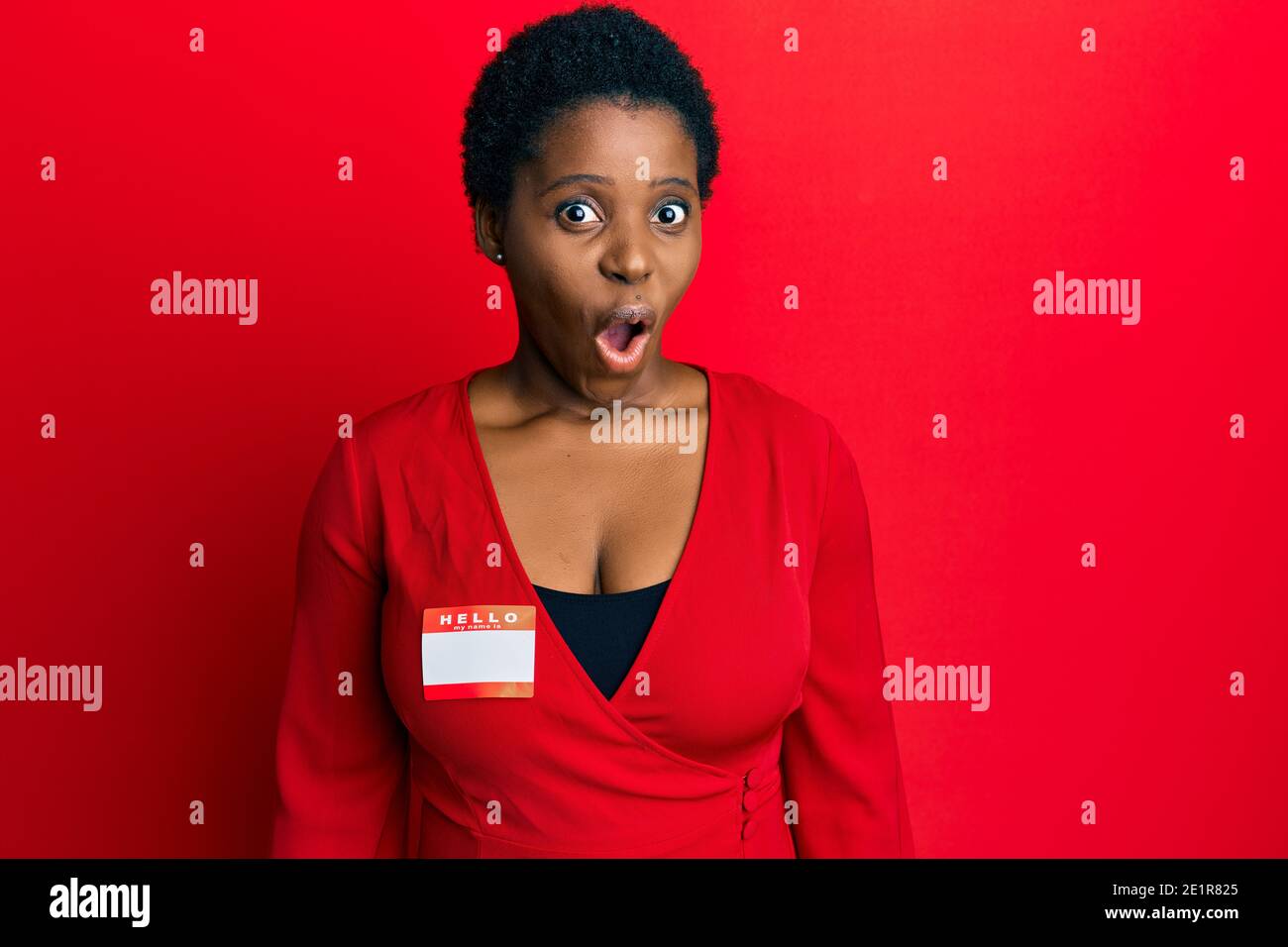 Young african woman with short hair wearing hello my name is sticker ...