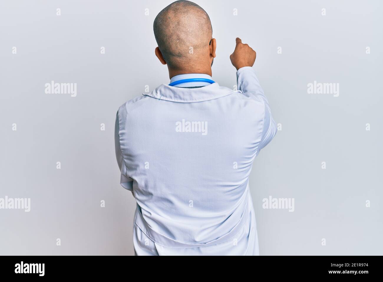 Hispanic adult man wearing doctor uniform and stethoscope posing ...