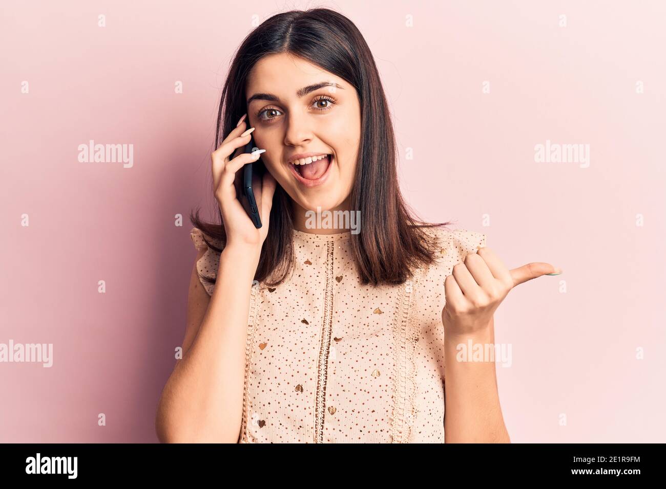 Young beautiful girl having conversation talking on the smartphone ...