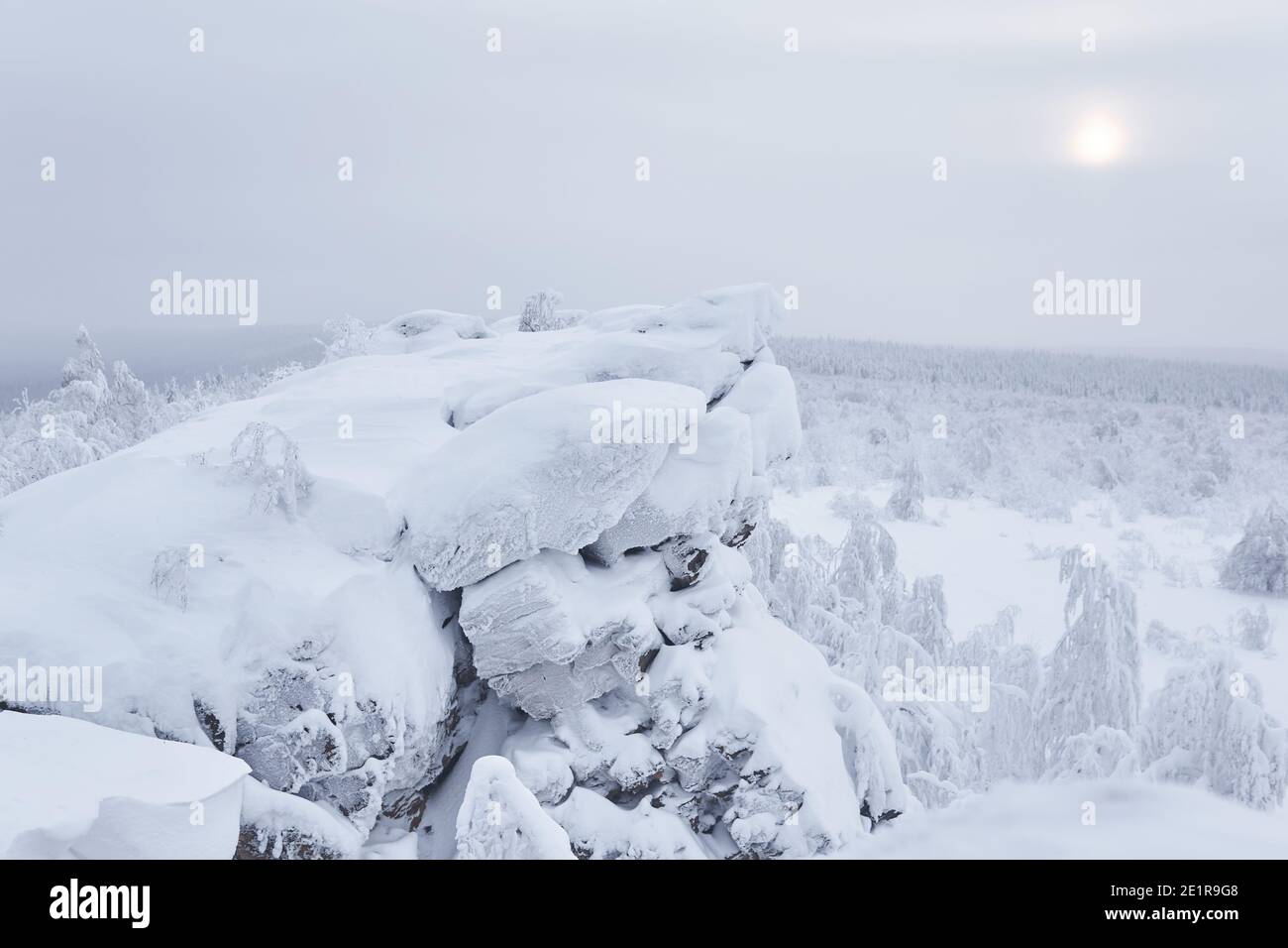 winter view from rocky mountain ridge to the snowy wooded hills in ...