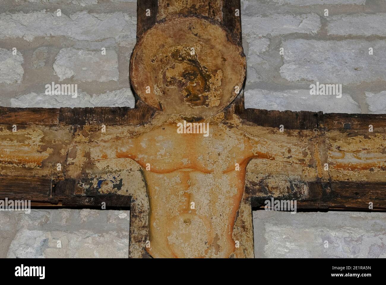 This ancient wooden cross bearing a fragmentary painting of the ...
