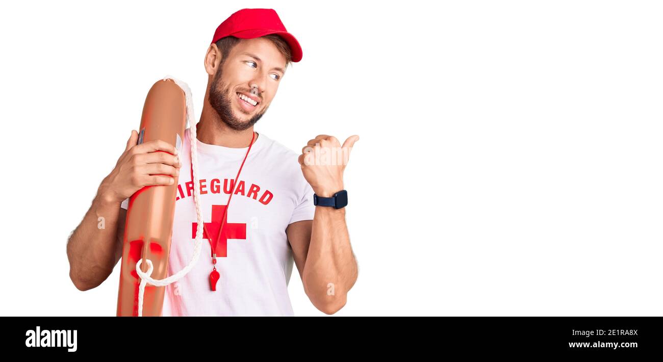 Young caucasian man wearing lifeguard t shirt holding float pointing ...