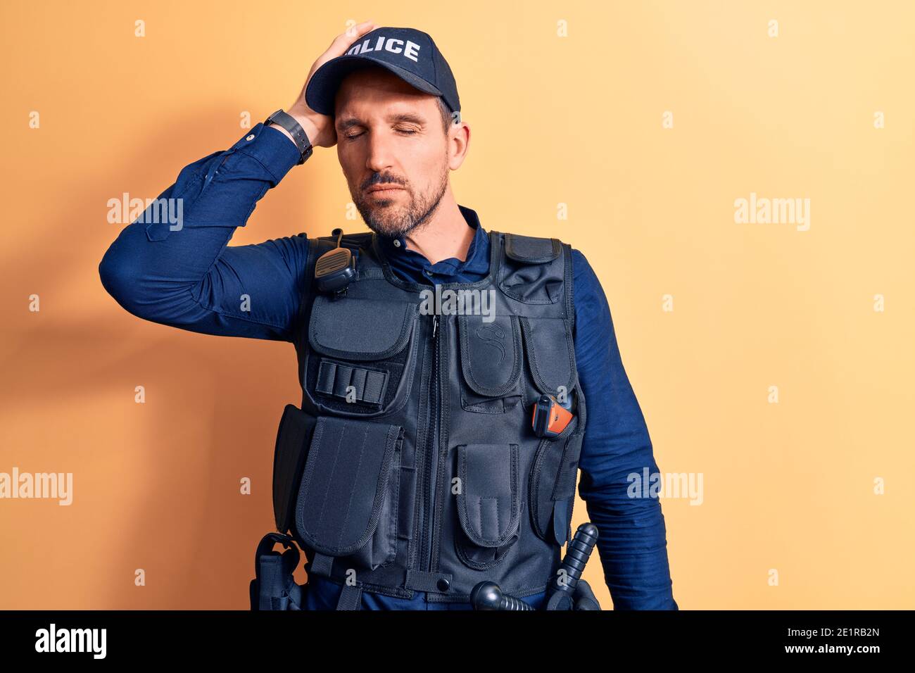 Young handsome policeman wearing police uniform and bulletprof over ...