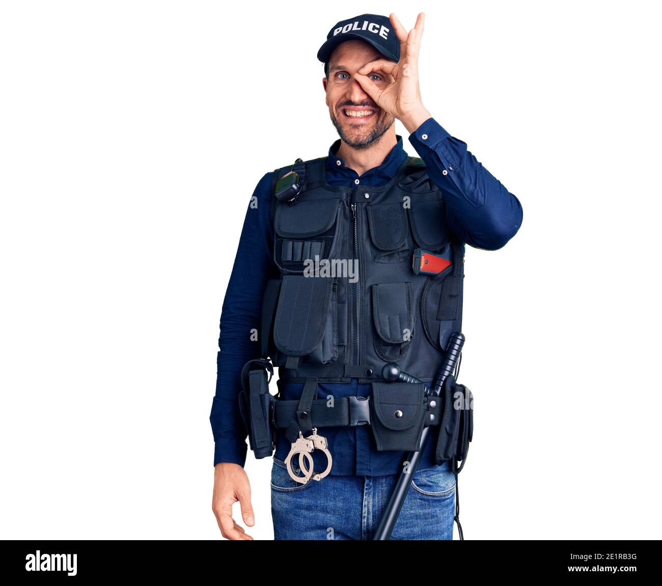 Young handsome man wearing police uniform doing ok gesture with hand ...