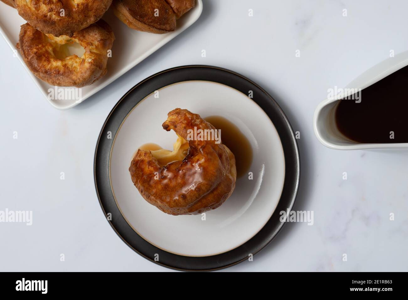 A single Yorkshire pudding viewed from the top covered in gravy and ...
