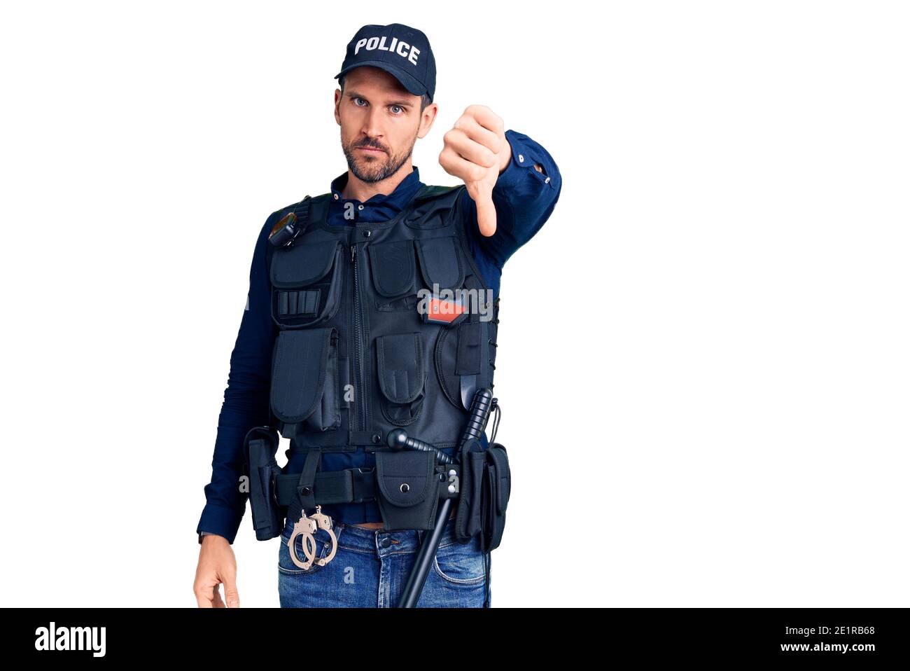 Young handsome man wearing police uniform looking unhappy and angry ...