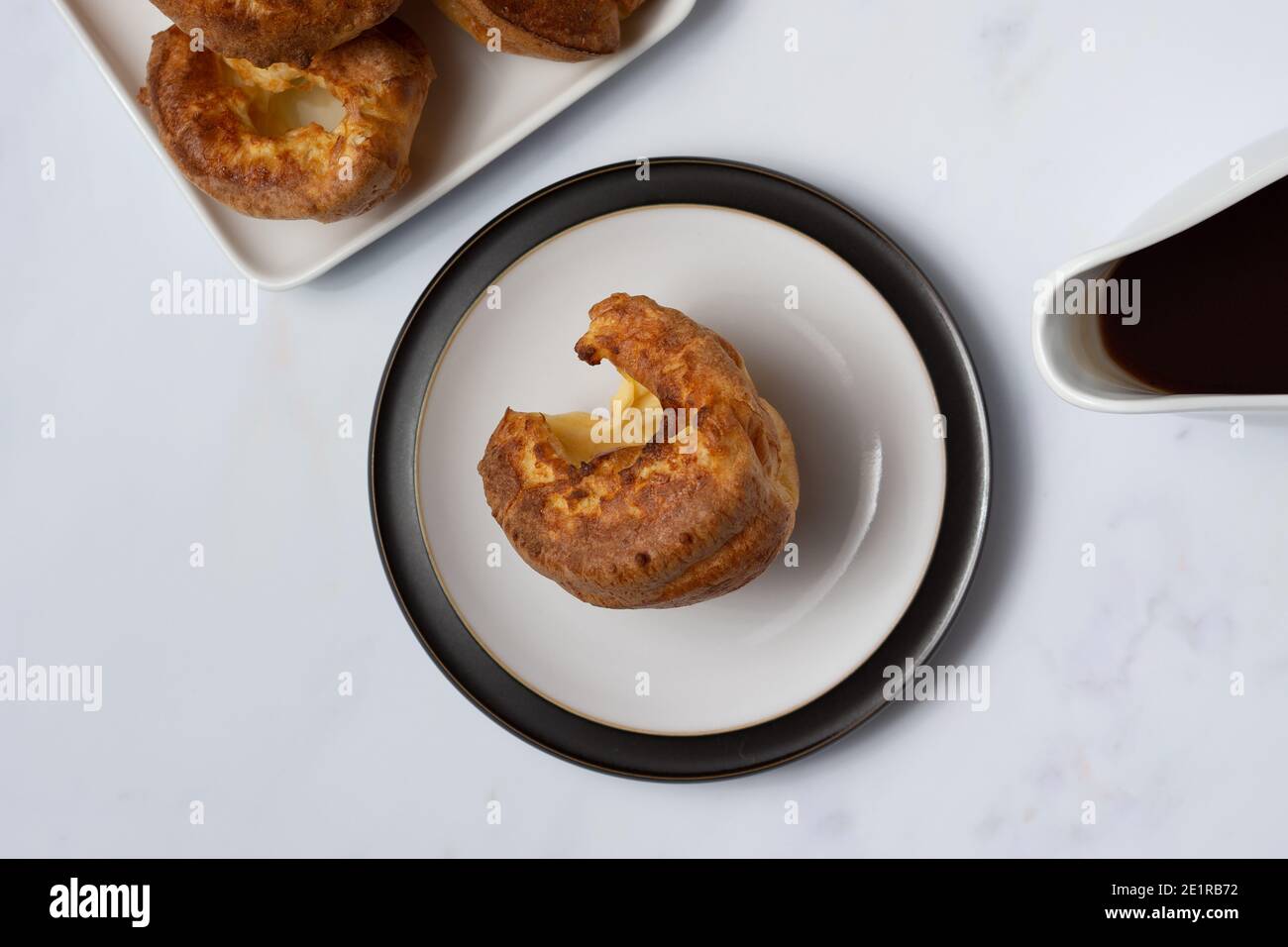A single Yorkshire pudding viewed from the top down sitting on a black ...