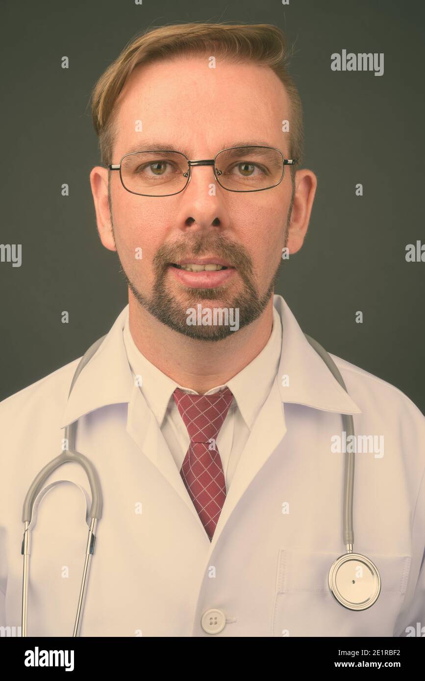 Blond bearded man doctor with goatee against gray background Stock ...
