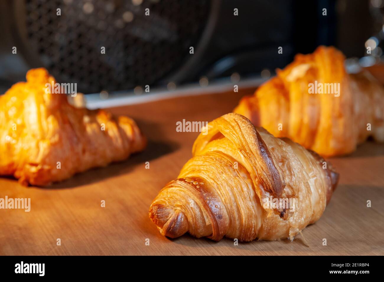 Baking croissants in an oven Stock Photo - Alamy