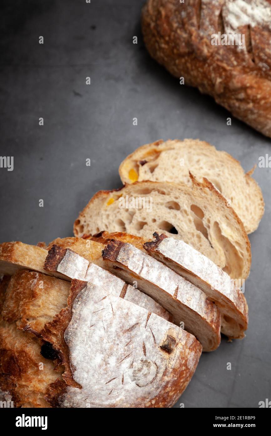 Sliced sourdough bread on dark cement background Stock Photo - Alamy
