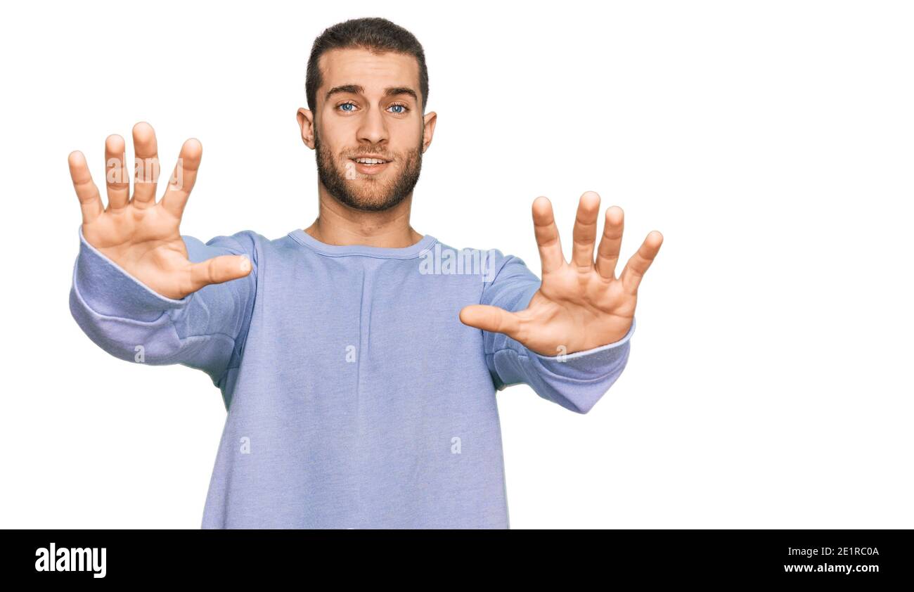 Young caucasian man wearing casual clothes afraid and terrified with ...