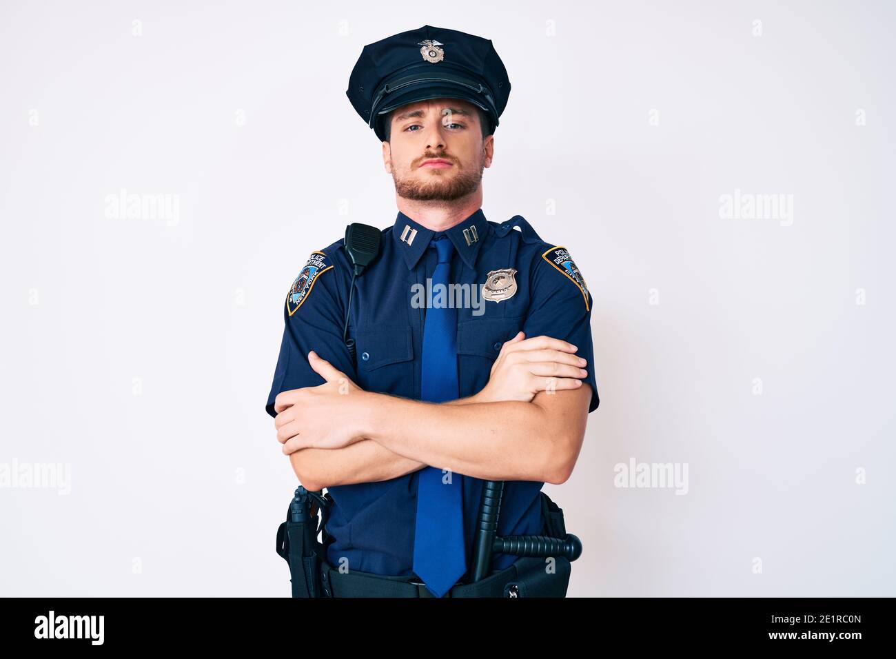 Young caucasian man wearing police uniform skeptic and nervous ...
