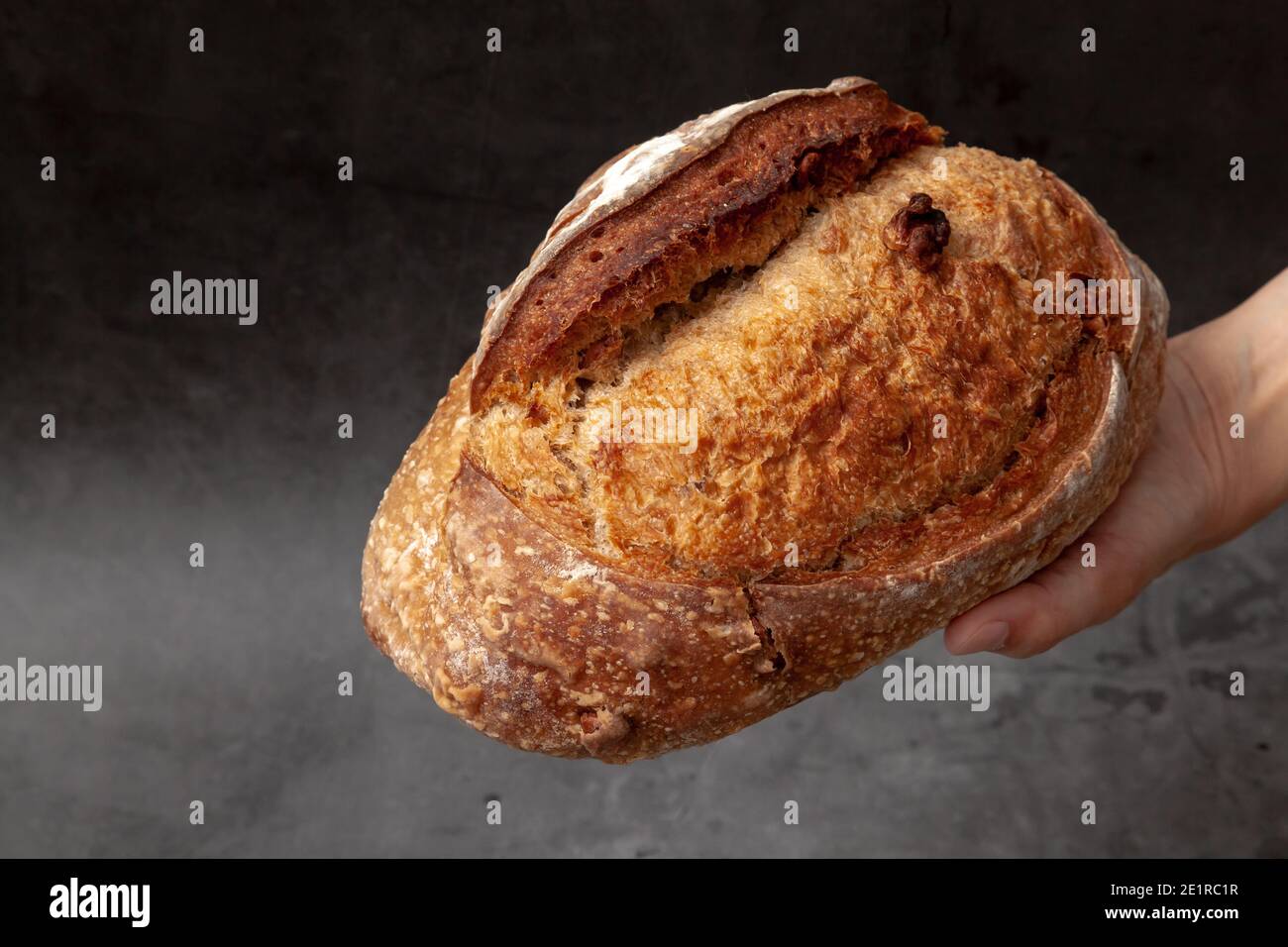 Sourdough bread with mixed fruits and nuts on dark cement background ...