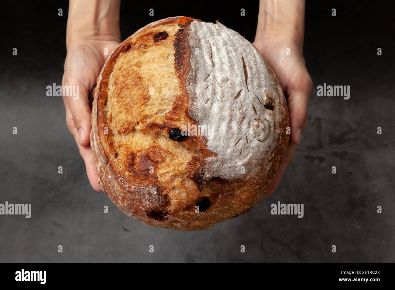 Sourdough bread with mixed fruits and nuts on dark cement background ...