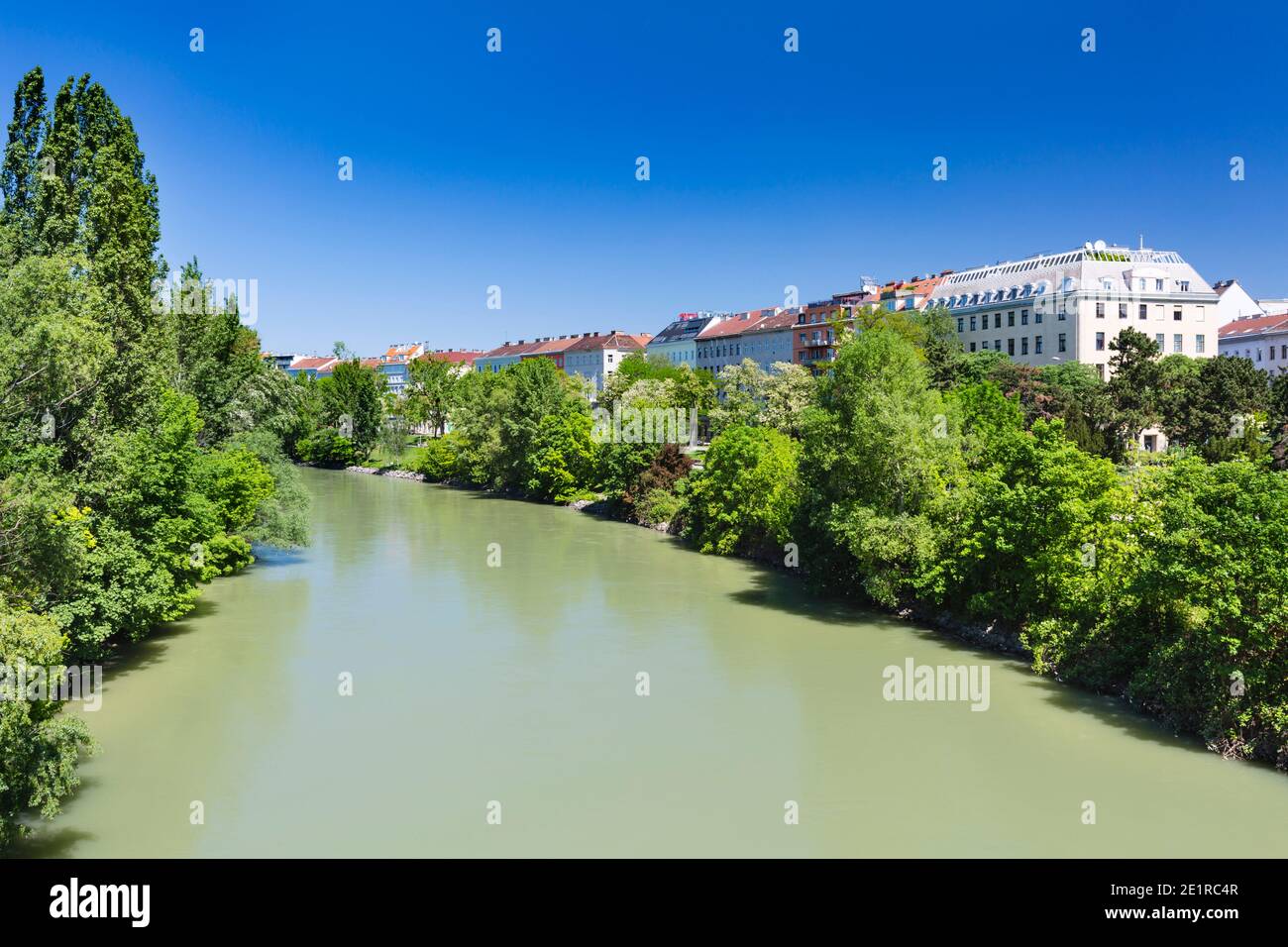The Vienna Danube Canal near the Augarten with green trees and blue sky ...