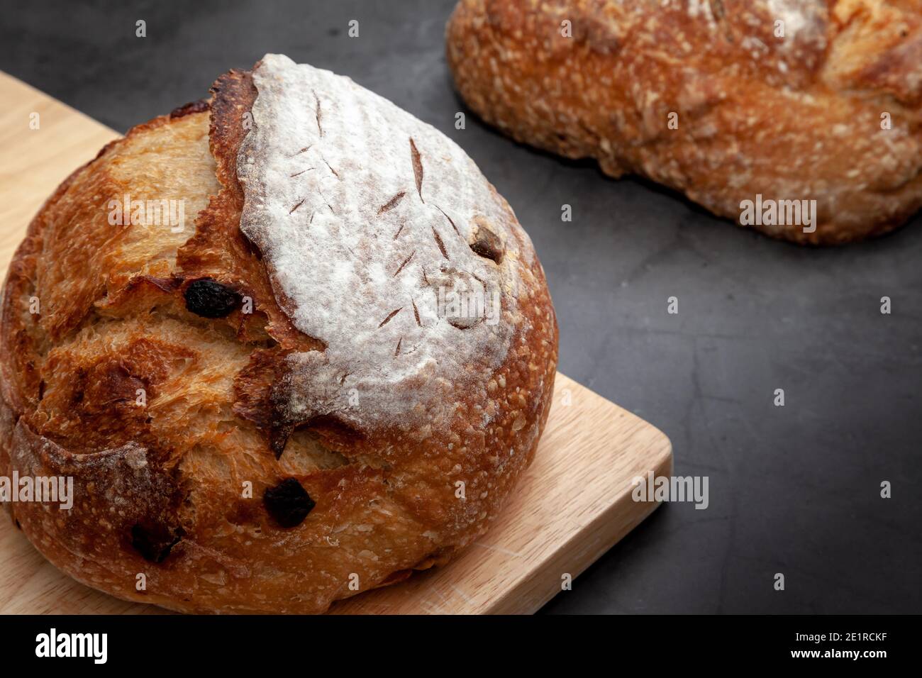 Sourdough bread with mixed fruits and nuts on dark cement background ...