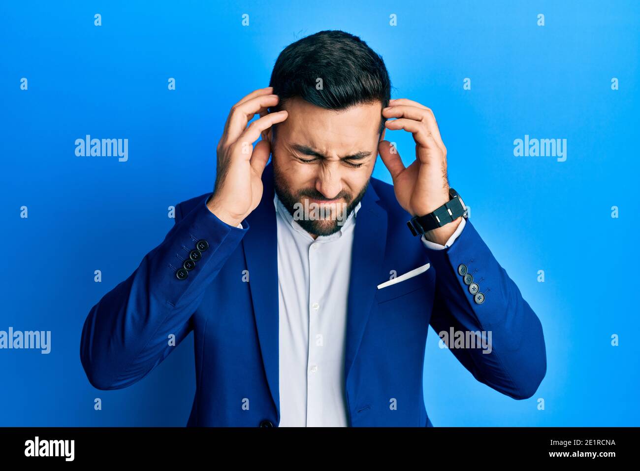 Young hispanic businessman wearing business jacket suffering from ...