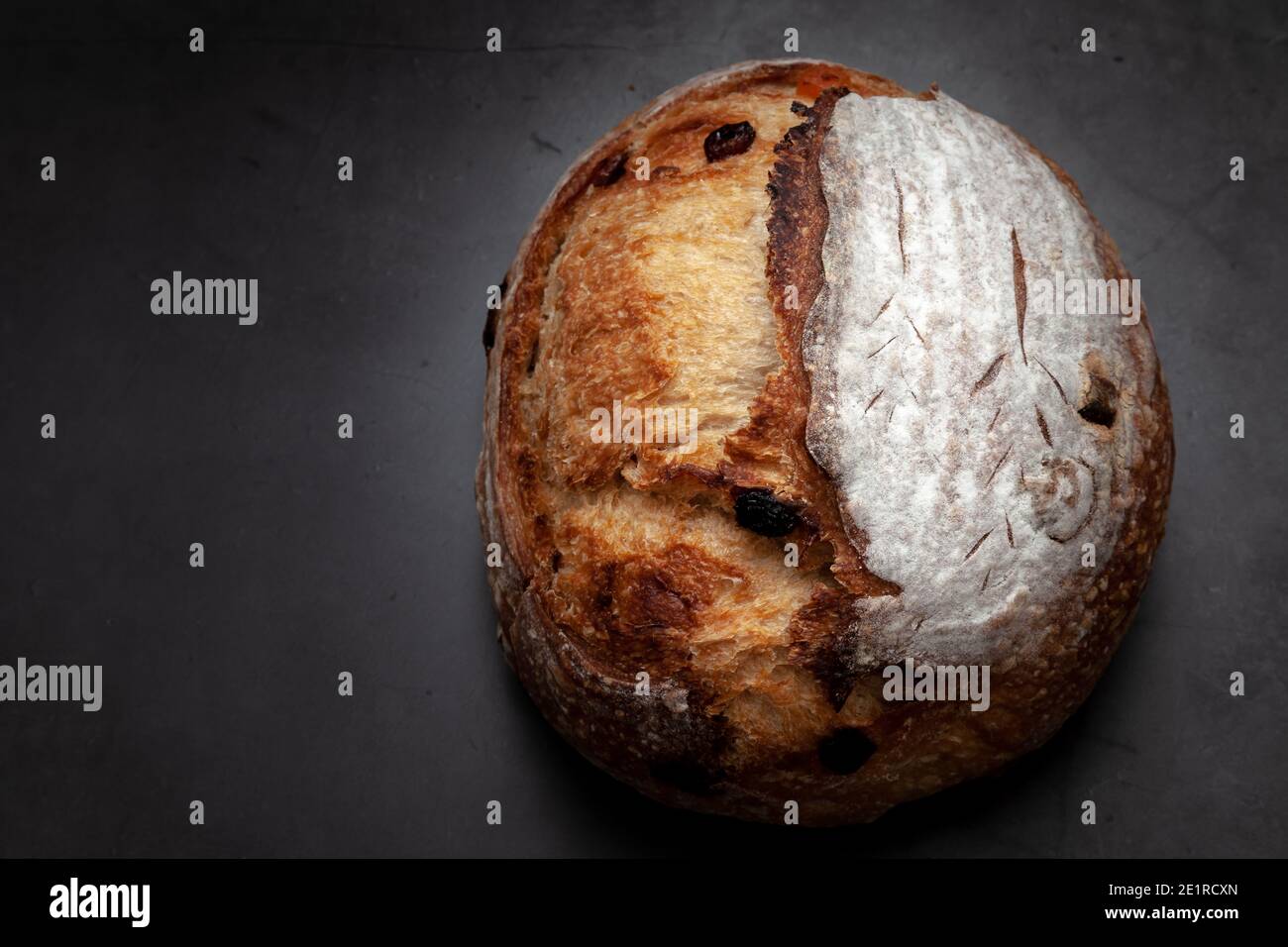 Sourdough bread with mixed fruits and nuts on dark cement background ...