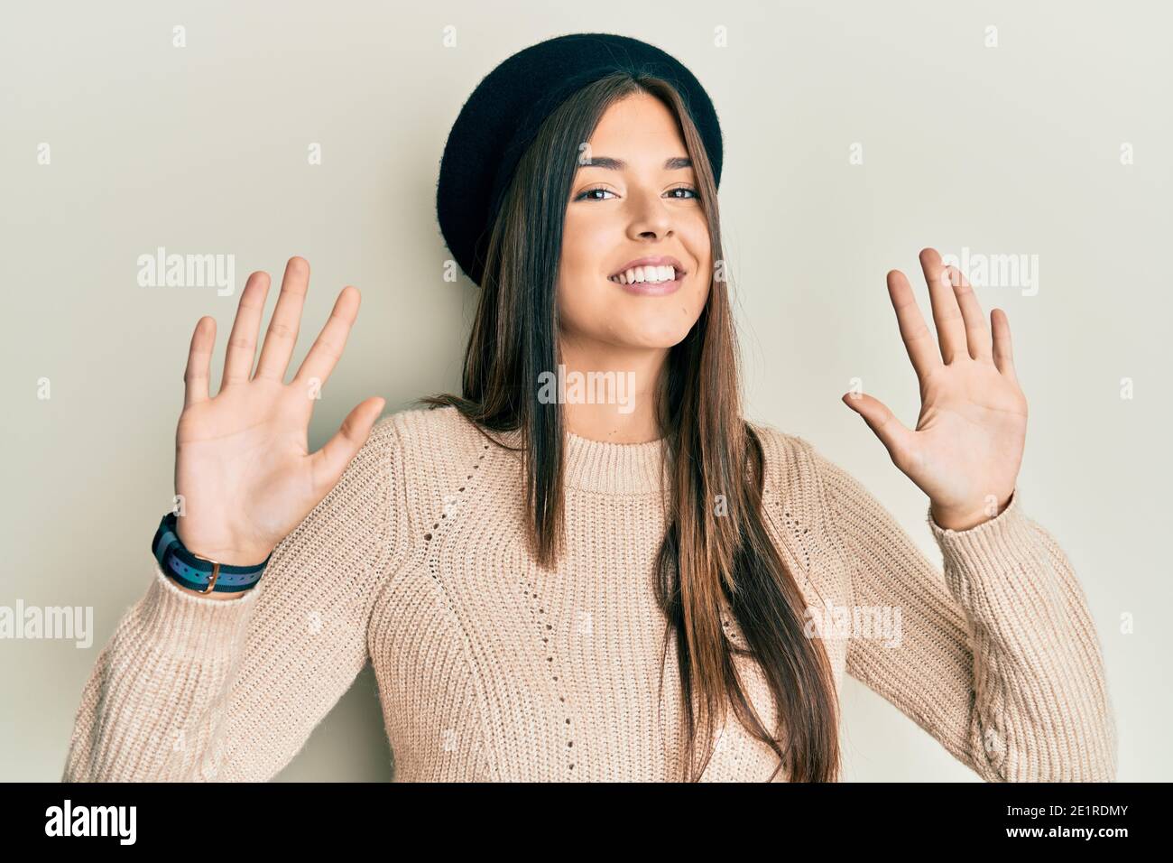 Young brunette woman wearing french look with beret showing and ...