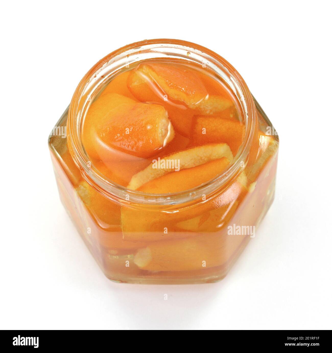 Orange peel preserve in a transparent jar isolated on white background ...