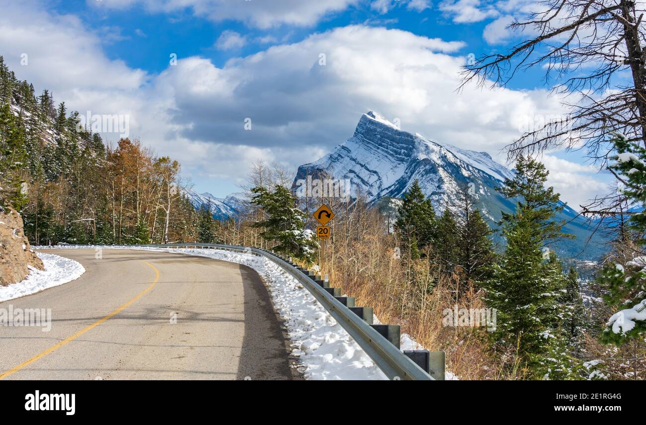 Snow-covered Mount Rundle with snowy forest mountain road. Mount ...