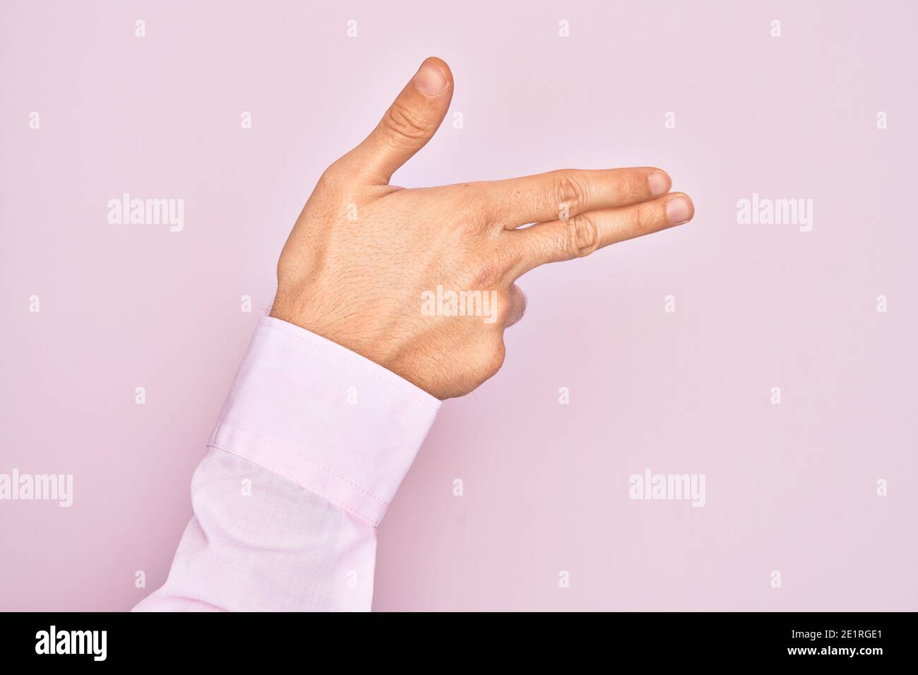 Hand of caucasian young man showing fingers over isolated pink ...