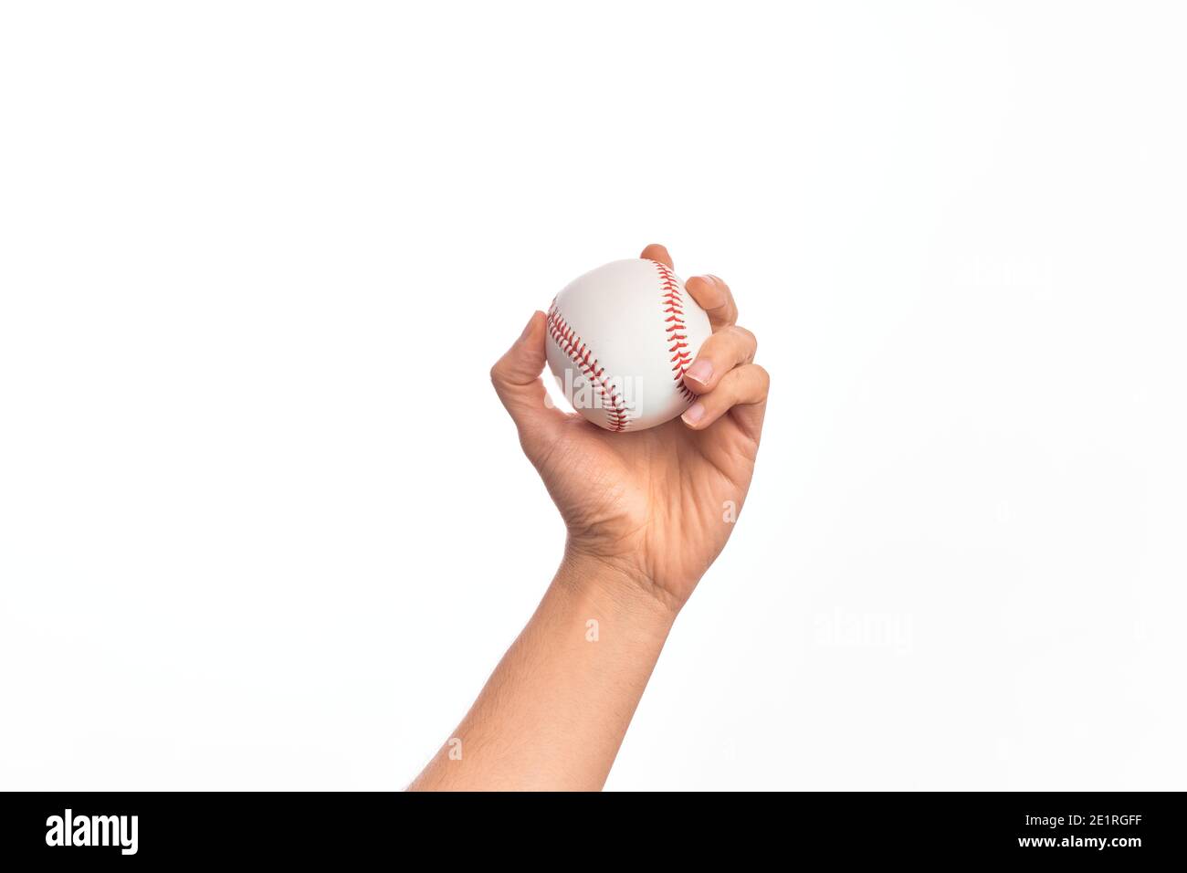 Hand of caucasian young man holding baseball ball over isolated white ...