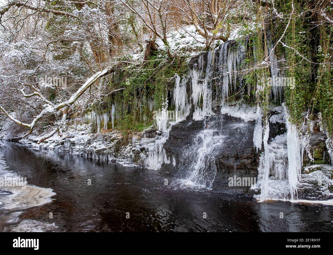 Snow and Ice covered waterfall flowing into the Linhouse Water ...