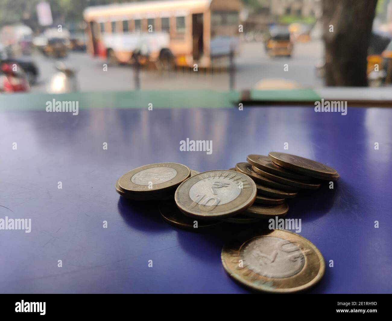 A bunch of Indian rupees ten coins kept on table with city street ...