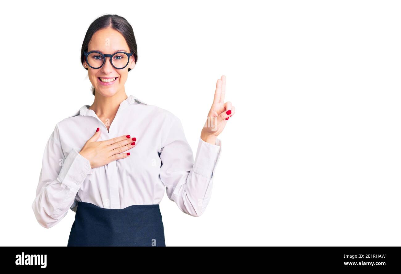 Beautiful brunette young woman wearing professional waitress apron ...
