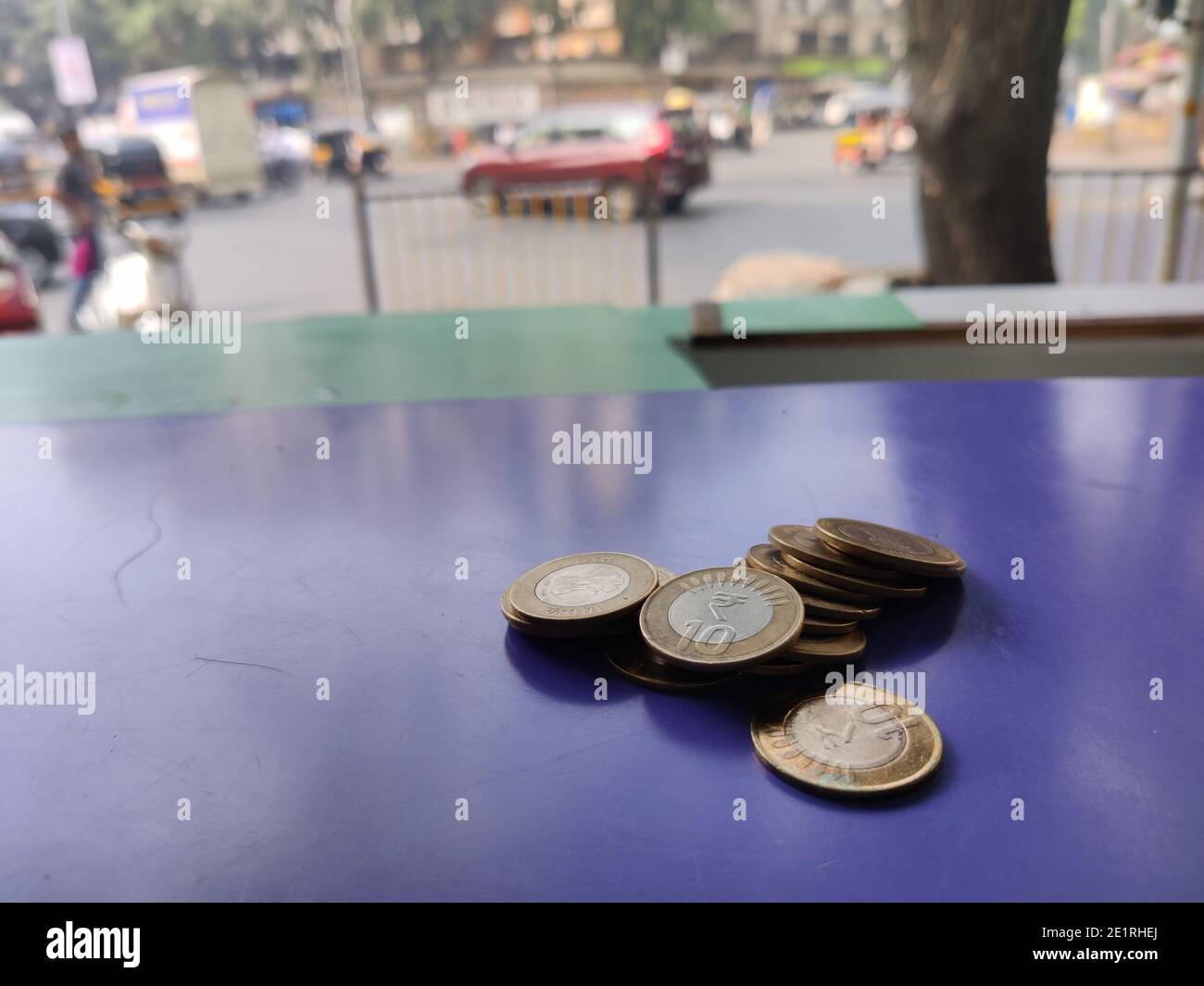 A bunch of Indian rupees ten coins kept on table with city street ...