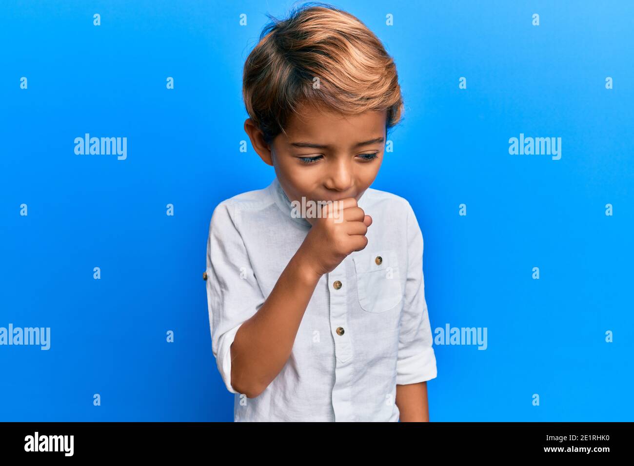 Adorable latin kid wearing casual clothes feeling unwell and coughing ...