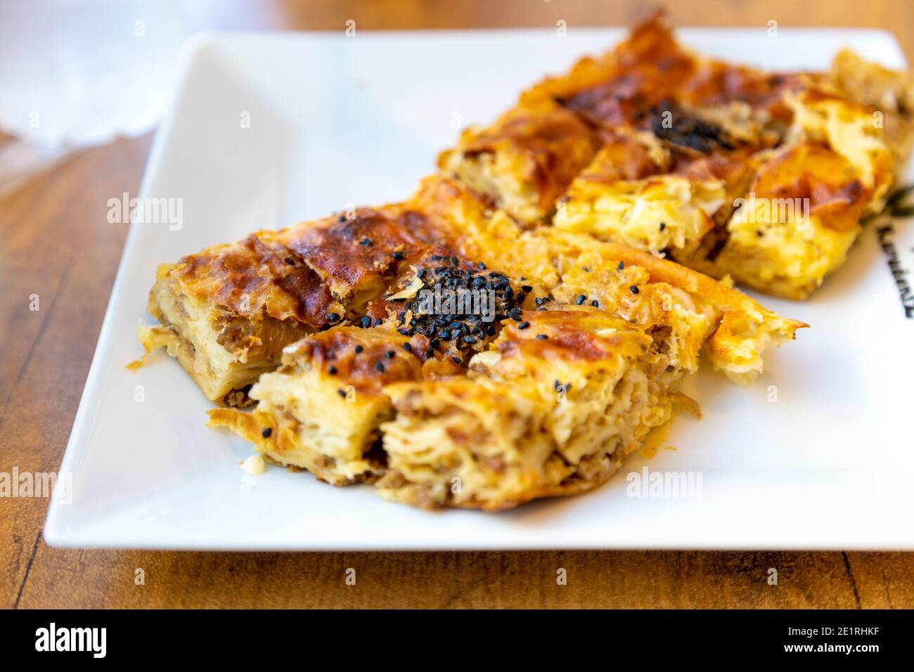 Traditional Turkish borek filo pastries topped with black nigella seeds ...