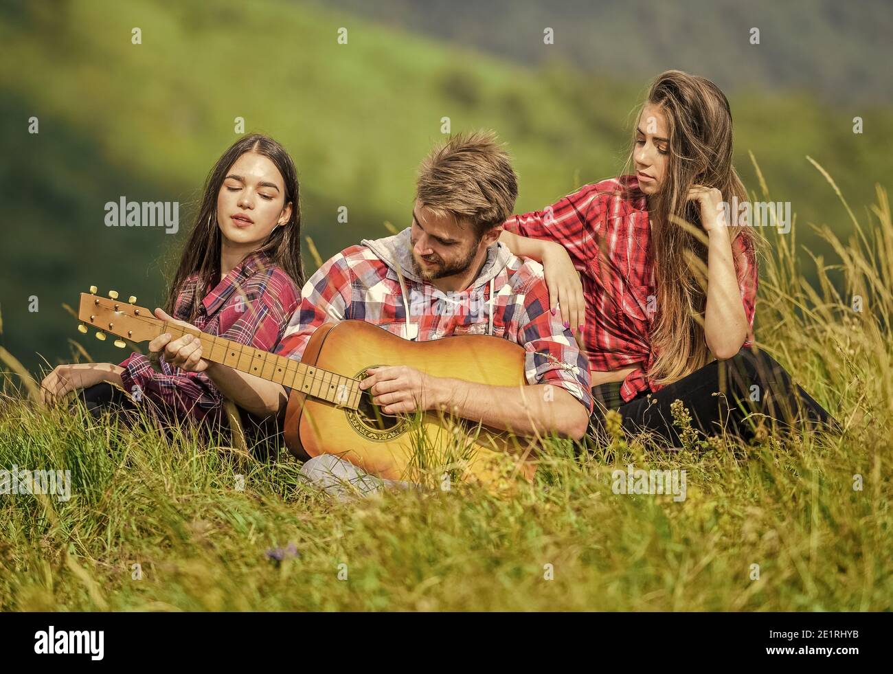 Friends hiking with music. Singing together. Musical pause. Hiking ...