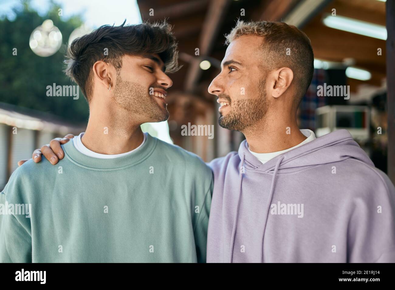 Young gay couple smiling happy and hugging at the city Stock Photo - Alamy